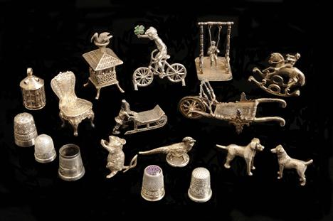 Twelve silver miniature figures together with five silver thimbles to ...