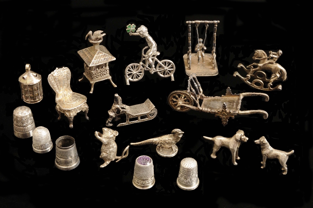 Twelve silver miniature figures together with five silver thimbles to ...