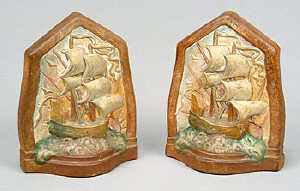 A pair of Compton Pottery bookends, with pointed tops and each moulded ...