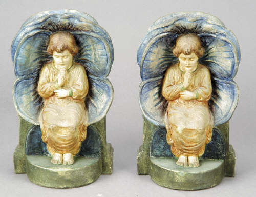 A pair of Compton Pottery figural bookends, each modelled and painted ...