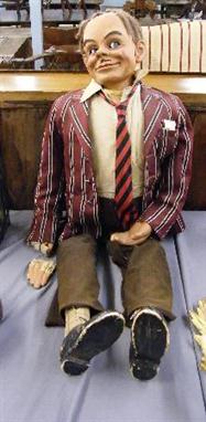 Papier mache ventriloquist`s dummy modelled as a boy in non-matching ...