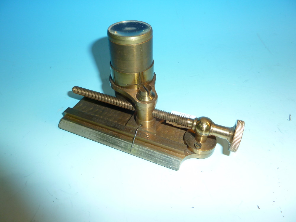 A brass thread counter with swivel lens, twin scales, by J Casartelli ...